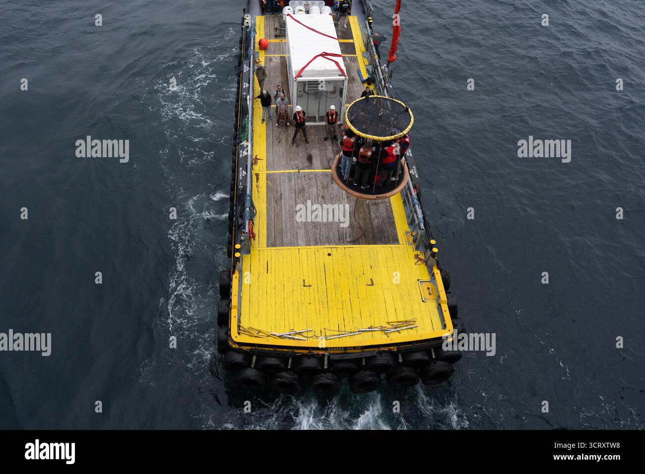Expedition 501 members and crew are lifted from the Gaspee, a crew ...
