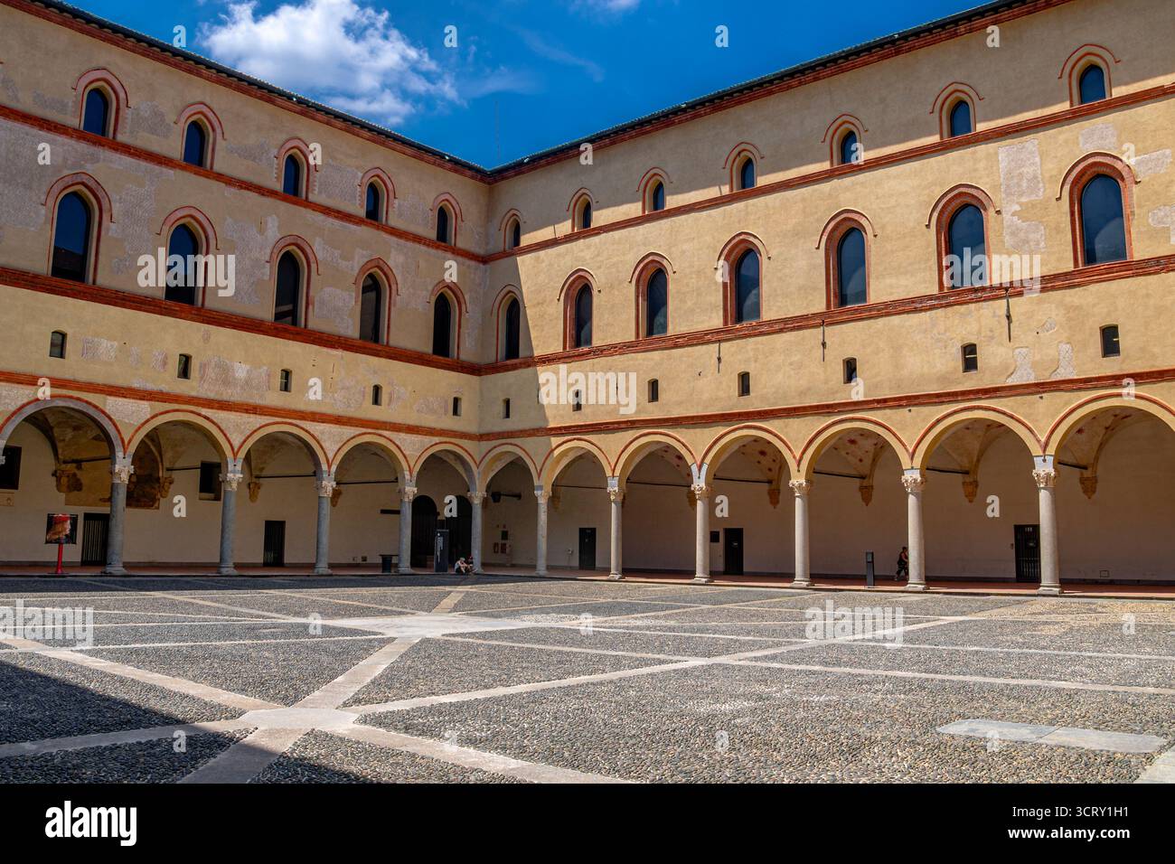 Elegant courtyrd surrounded by arches and a portico inside Sforzesco ...
