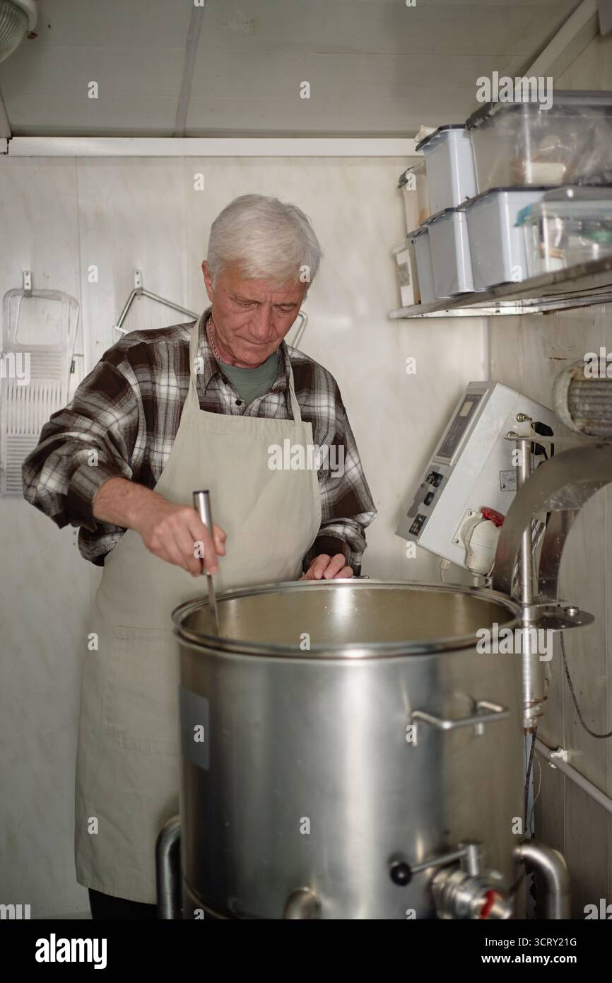 Professional male cook stirring large hi-res stock photography and ...