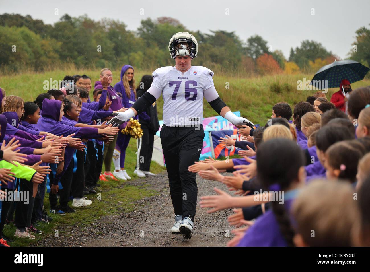 Minnesota Vikings guard Will Fries (76) high fives students after they ...
