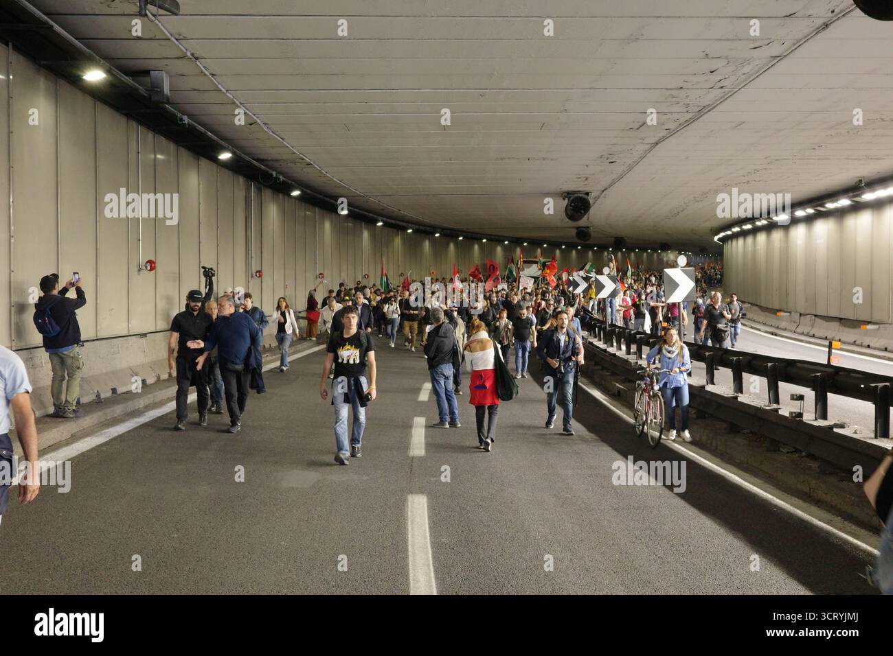 Rome, Italy. 03 October 2025. Protesters march through a tunnel road ...