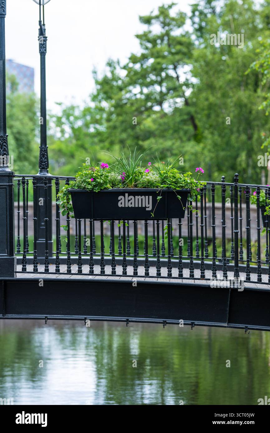 Flower arrangement on a bridge over a river Stock Photo - Alamy