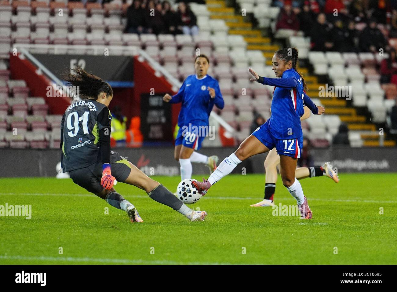 Manchester United goalkeeper Phallon Tullis-Joyce (left) saves at the ...