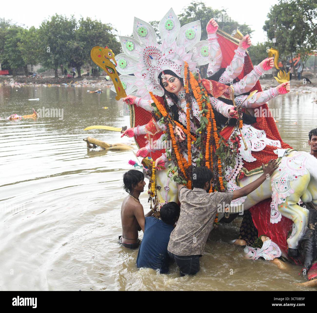 PATNA, INDIA - OCTOBER 3: Devotees immersing idol of Goddess Durga in ...