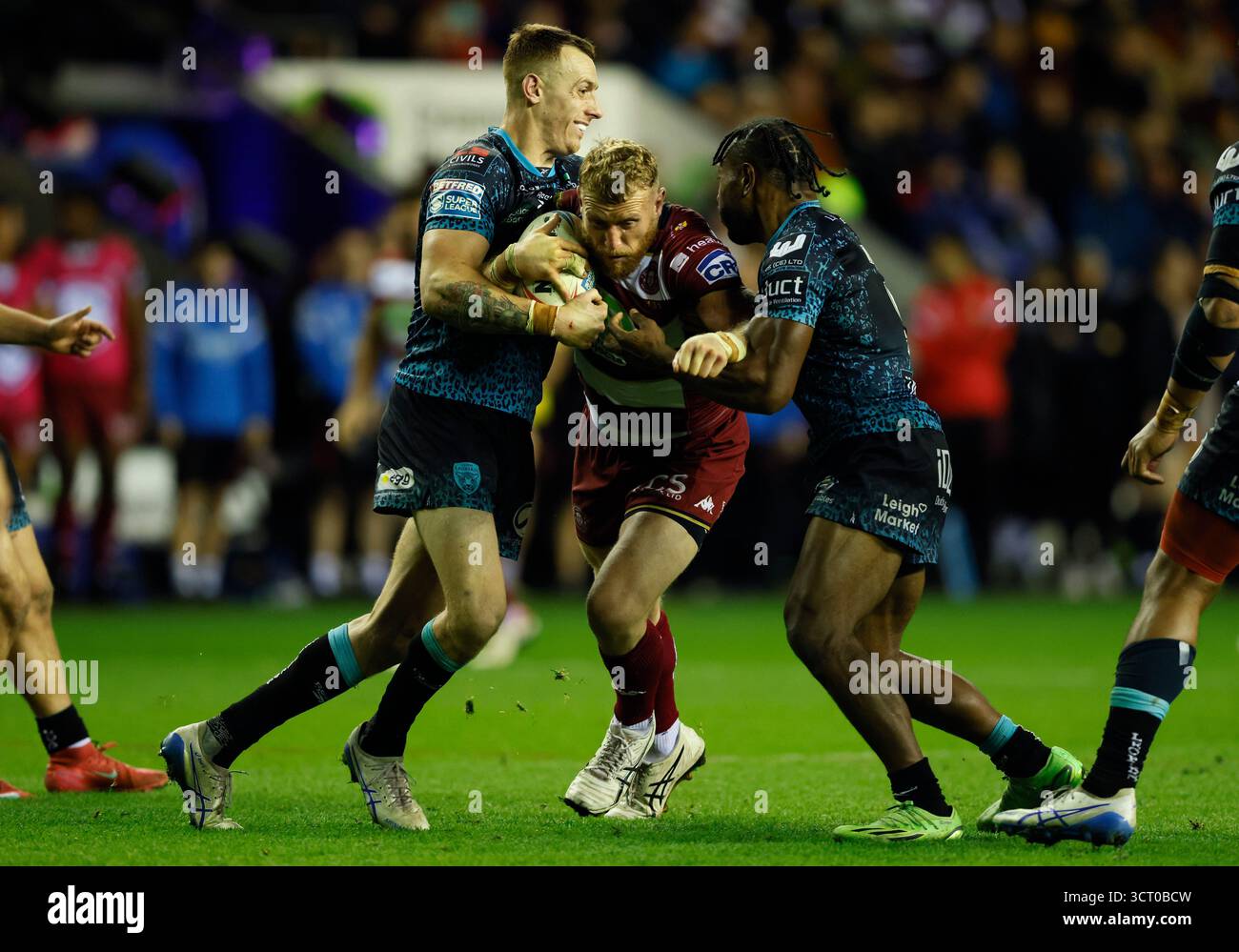 Wigan Warriors' Luke Thompson (centre) is tackled during the Betfred ...