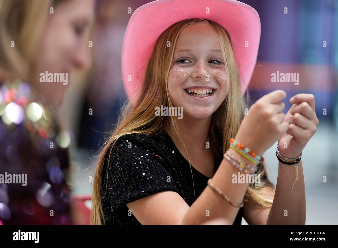 Hazel Gilbert, 10, builds a friendship bracelet during a release party ...
