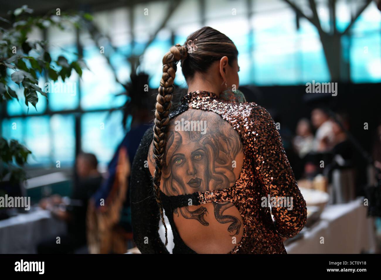 Aleen Sparrow, of the Musqueam Nation, models a dress and copper ...
