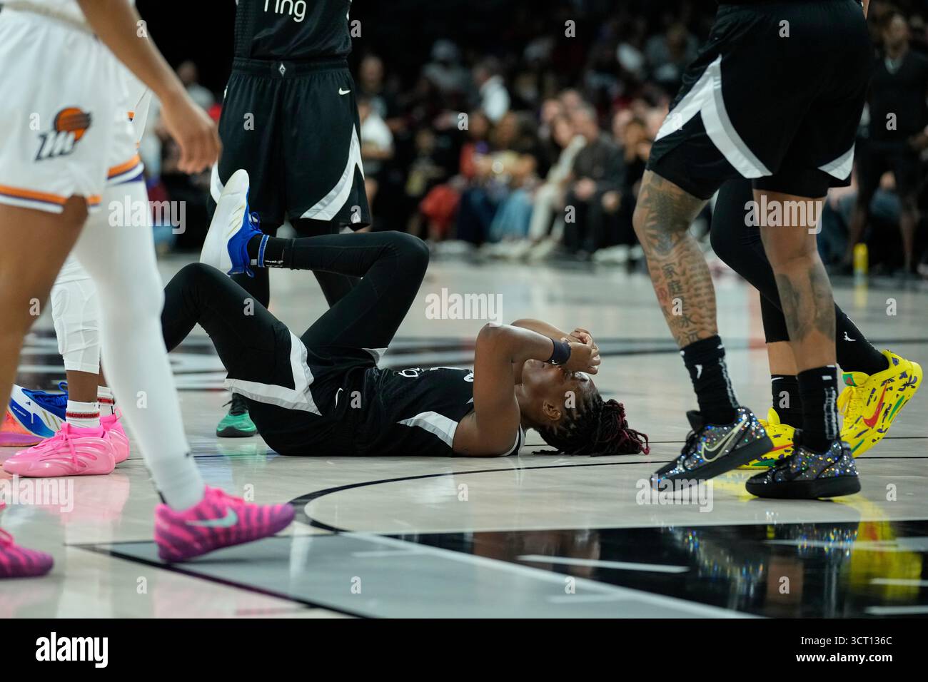 Las Vegas Aces guard Chelsea Gray lies on the court after a play ...