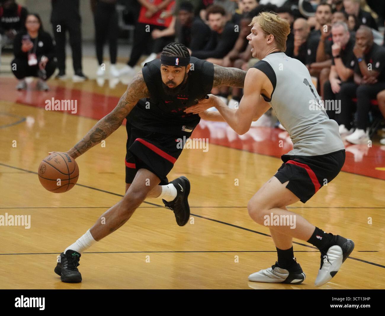 Toronto Raptors' Brandon Ingram, left, drives past Gradey Dick, right ...