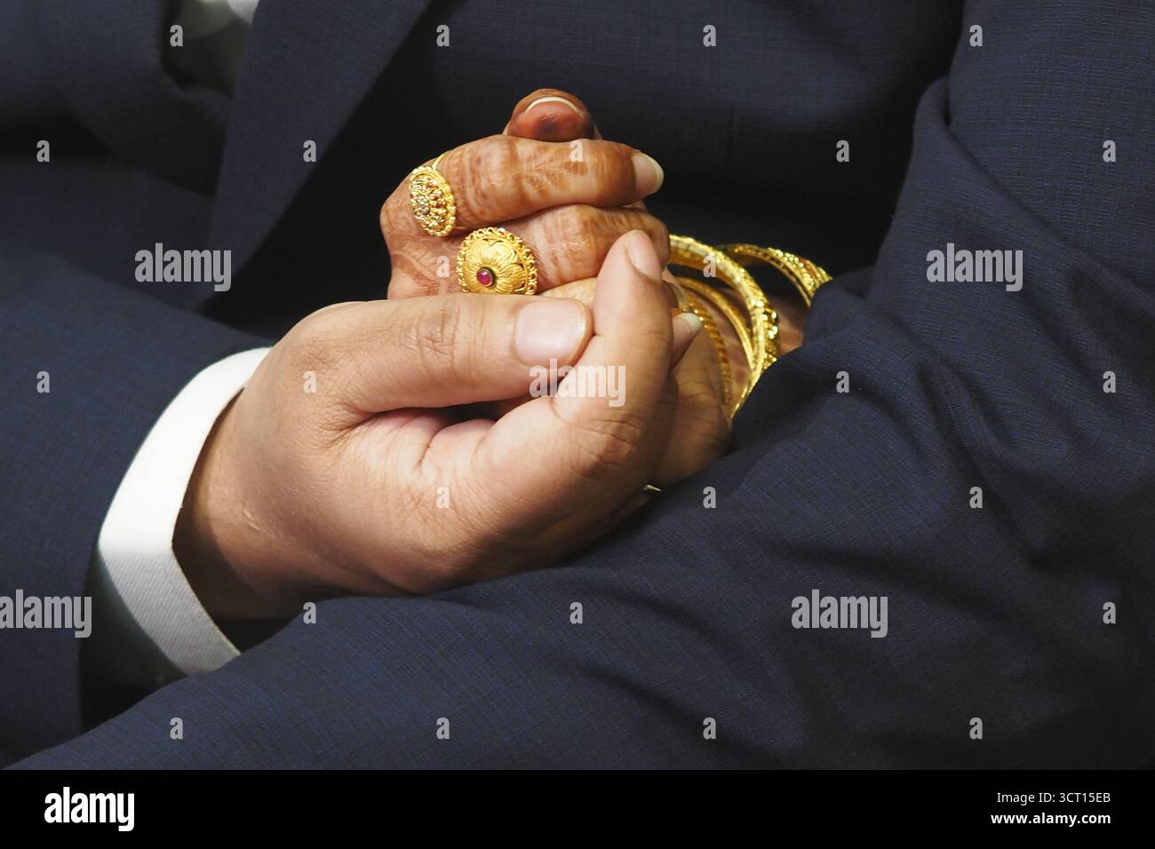 Hands gold bangles holding hi-res stock photography and images - Alamy