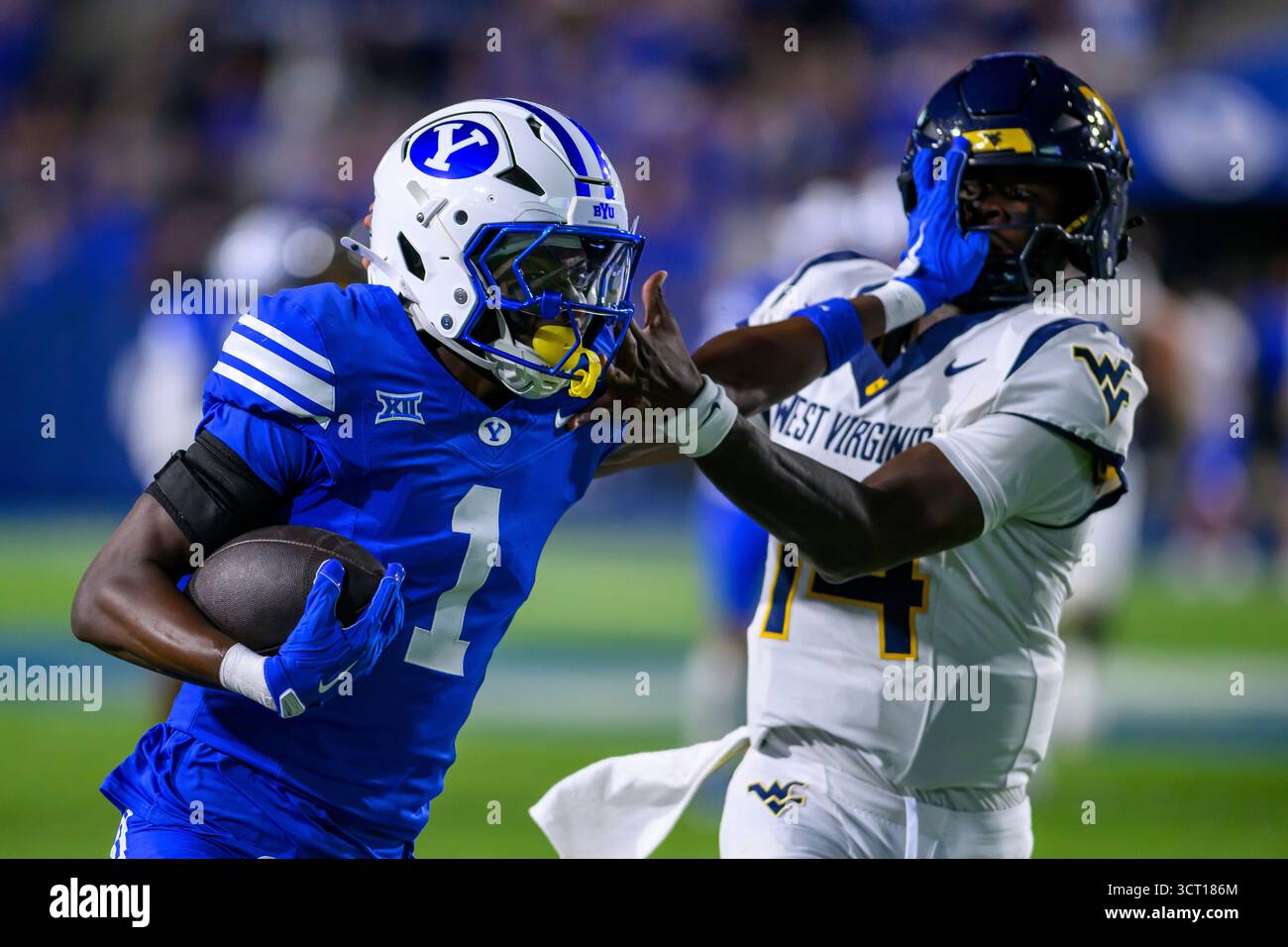BYU cornerback Therrian Alexander III (1) stiff-arms West Virginia ...