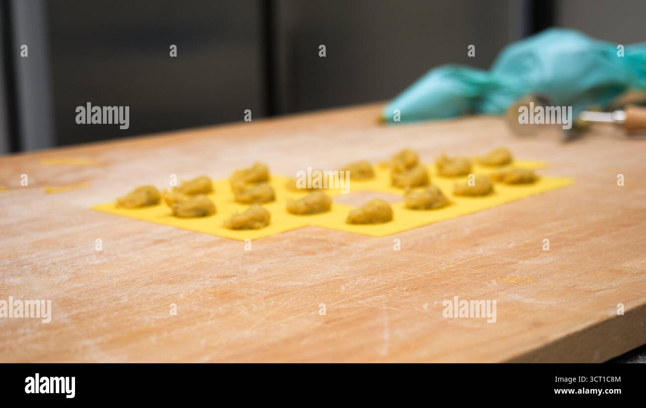 Close up of fresh vegetarian stuffed tortellini being carefully ...