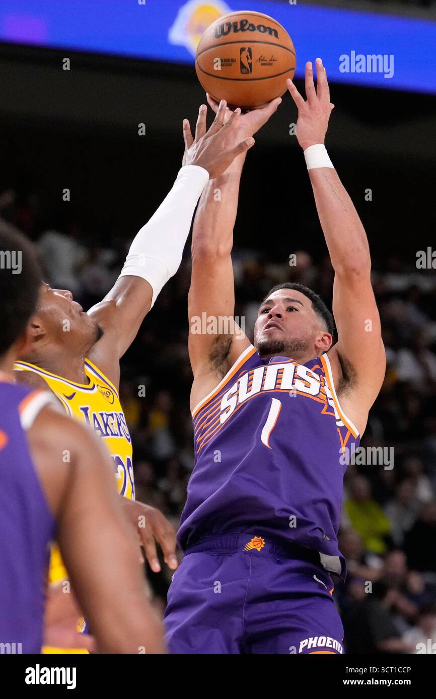 Phoenix Suns guard Devin Booker, right, shoots as Los Angeles Lakers ...