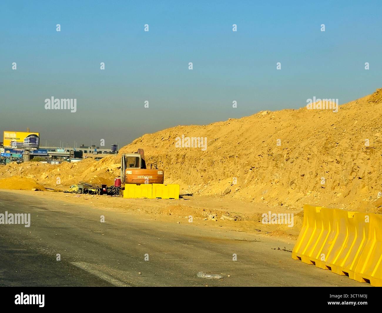 Cairo, Egypt, September 30 2025: A Hitachi hydraulic excavator removing ...