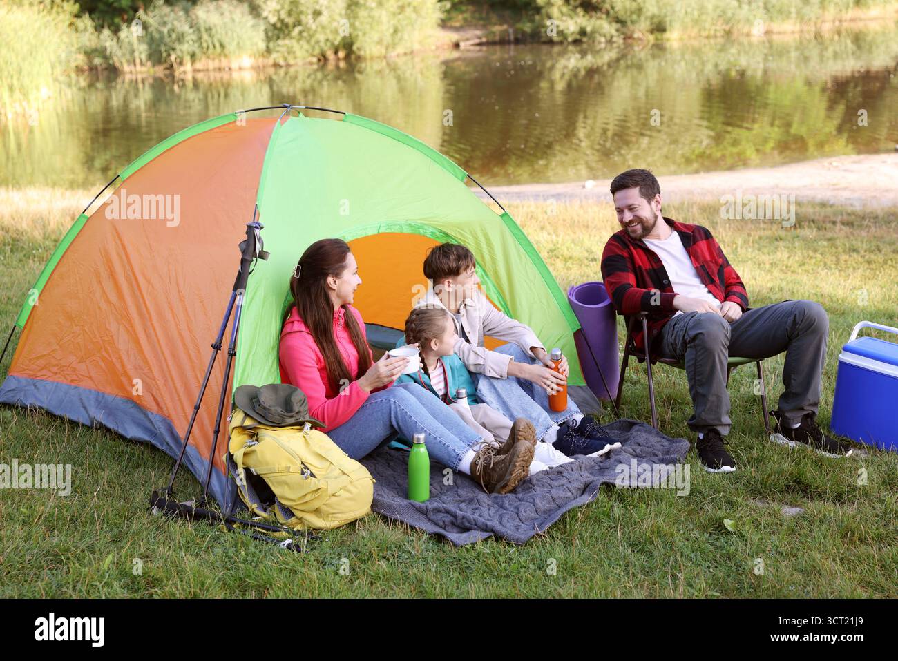 Happy family having break camping hi-res stock photography and images ...