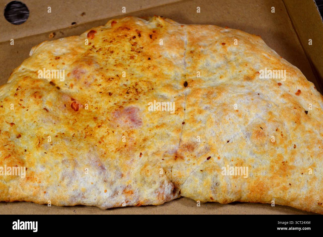 A half-moon-shaped sandwich, Pizza sandwich filled with Chicken with ...
