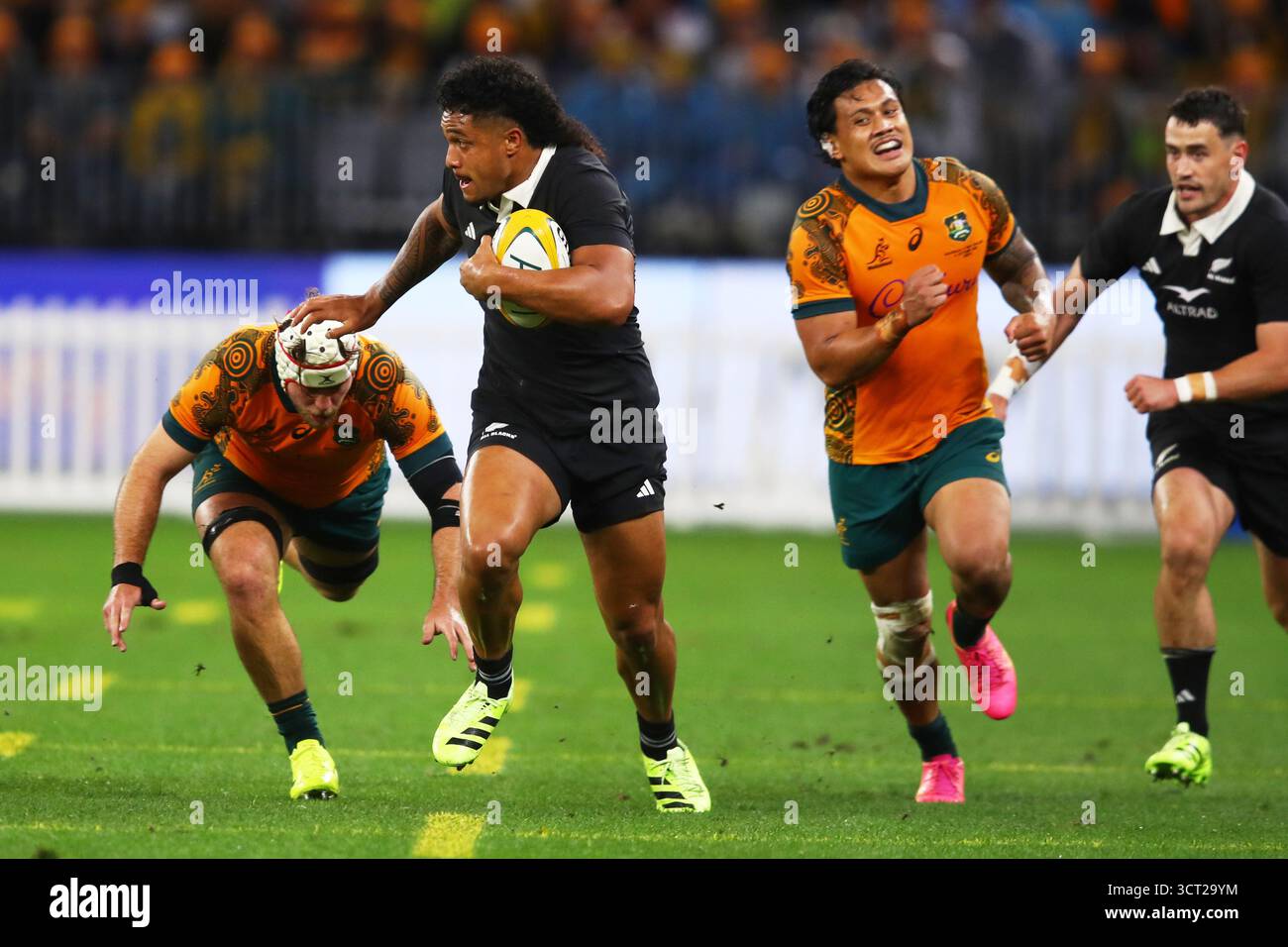 New Zealand's Leicester Fainga'anuku attempts to fend off Australia's ...