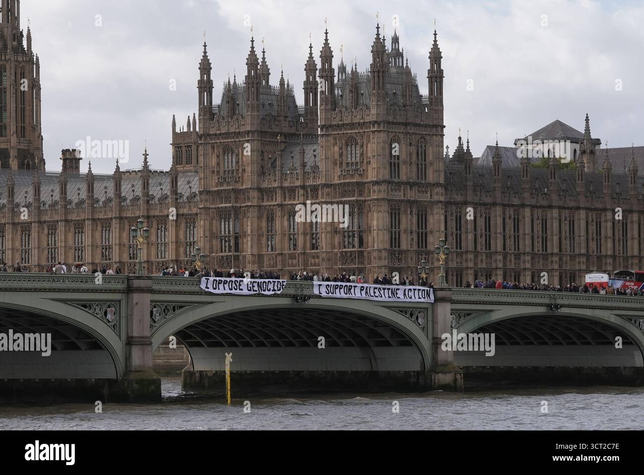 Protesters unfurl a banner on Westminster Bridge as part of a ...