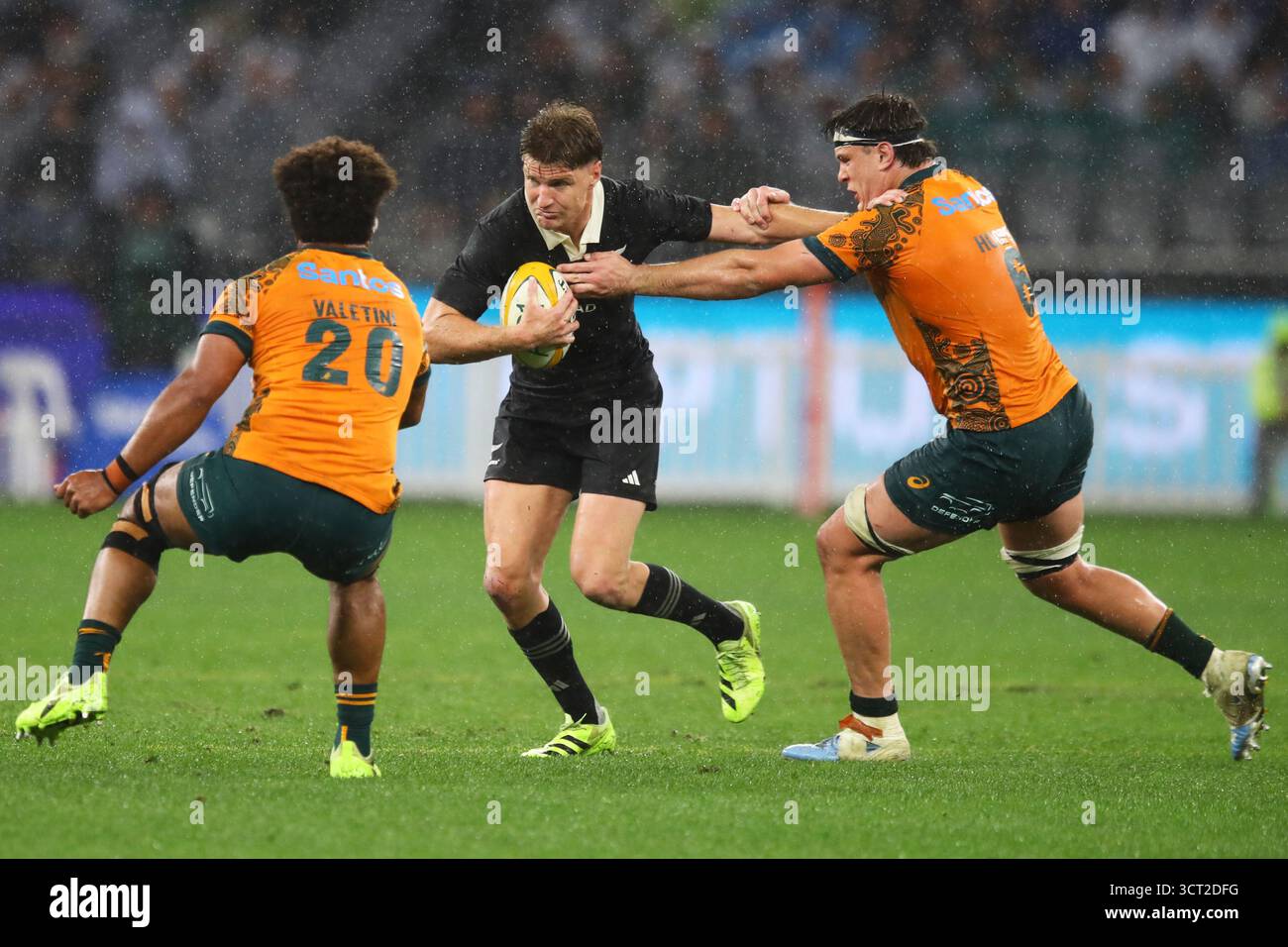 New Zealand's Jordie Barrett, centre, is tackled by Australia's Tom ...