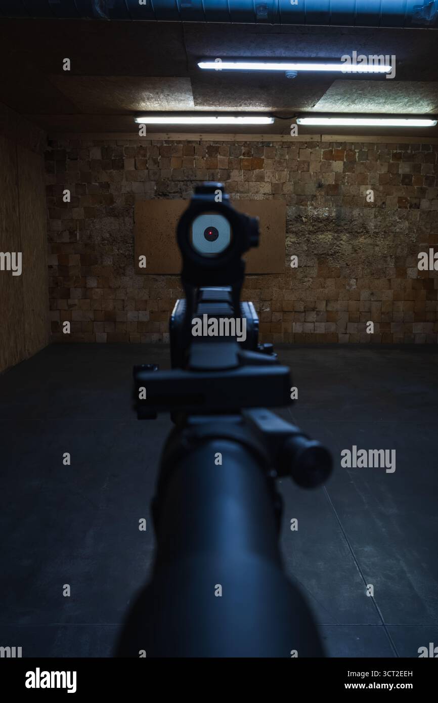 First-person shooter perspective aiming a modern rifle with a ...