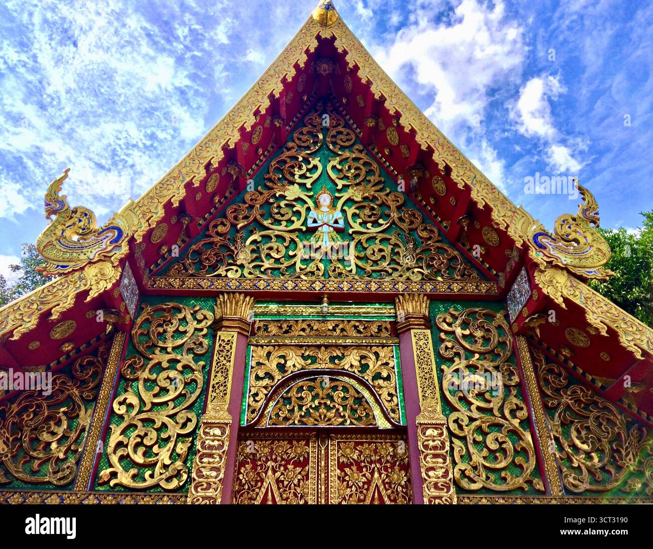 Golden nagas and floral motifs adorn the temple gable, Chiang Mai ...