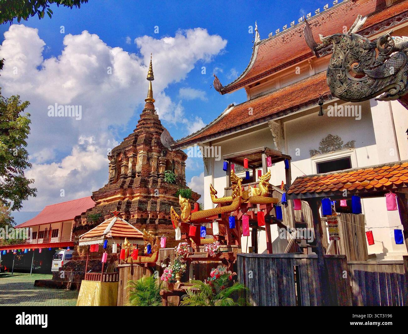 Temple complex with ancient stupa and festive decorations in Chiang Mai ...