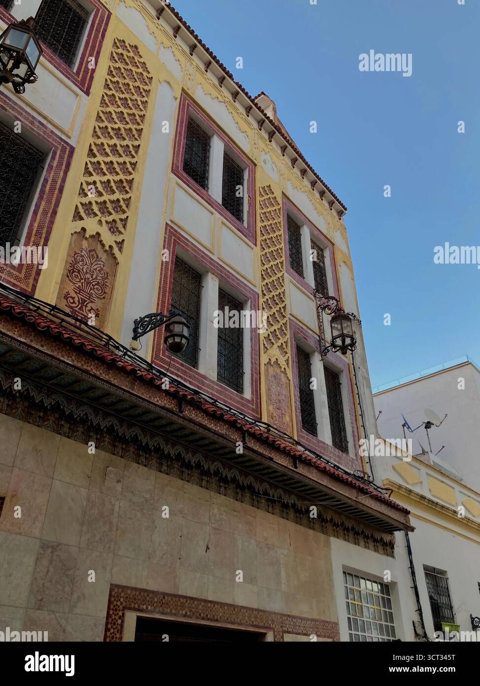 Classic Moroccan architecture with hanging lanterns and tiled roof trim ...