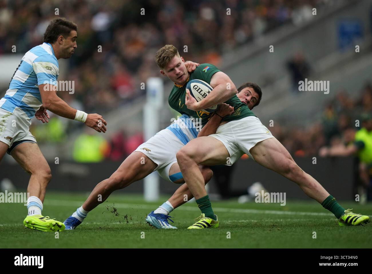 South Africa's Ethan Hooker, right, is tackled by Argentina's Bautista ...
