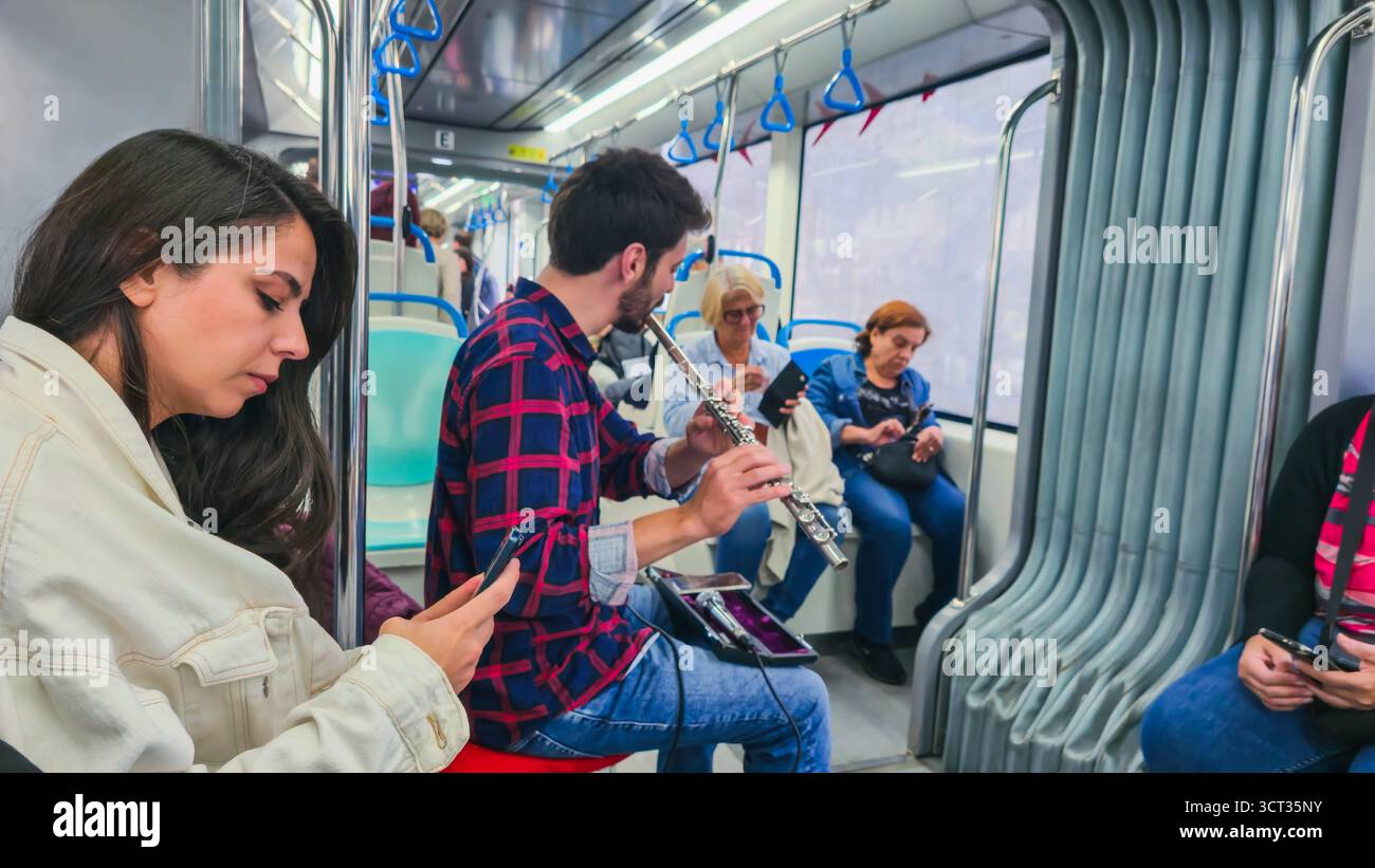 Street musician playing flute on metro train Street musician playing ...
