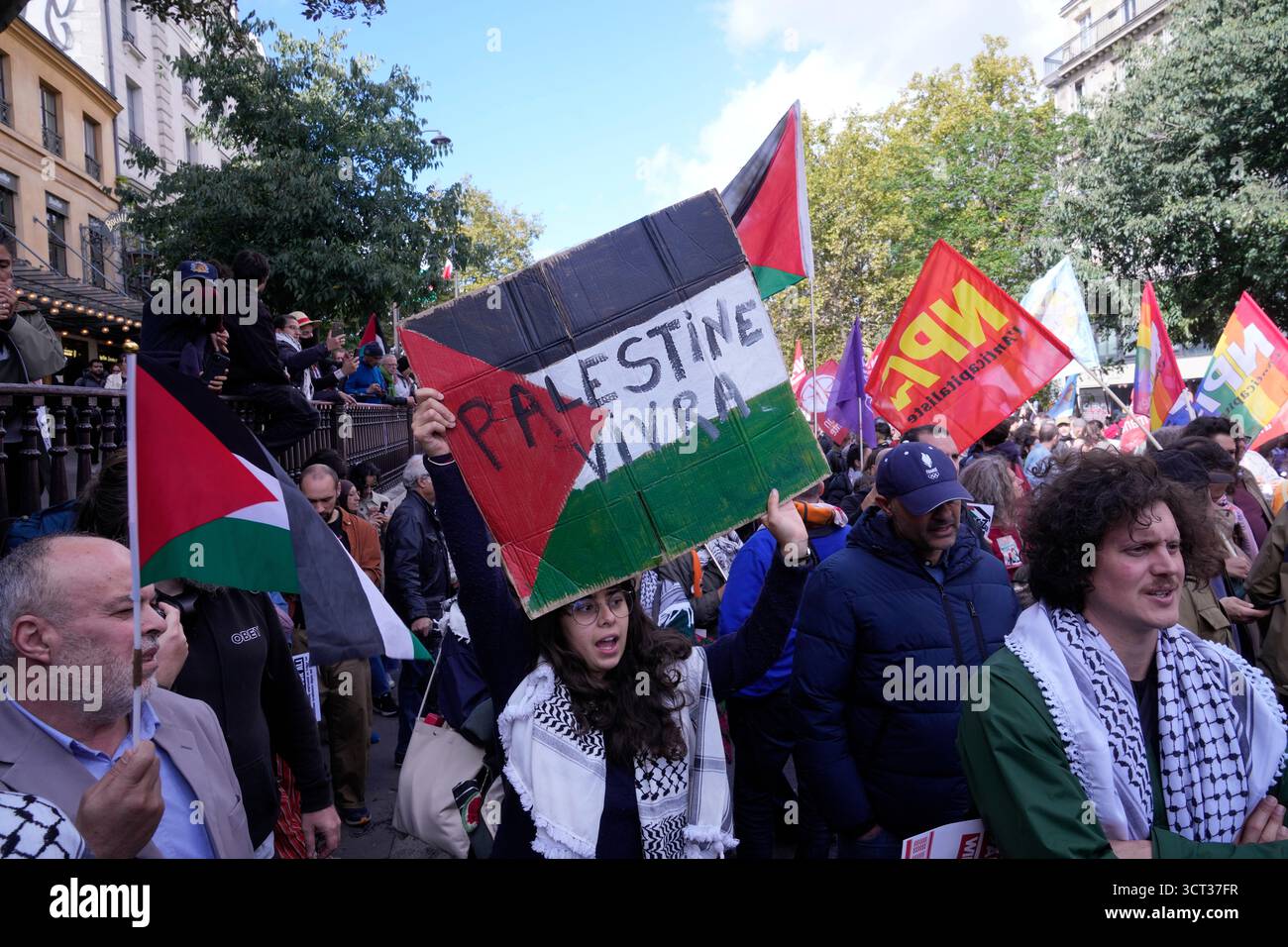 A demonstrator holds a placard that reads, "Palestine lives on," during ...
