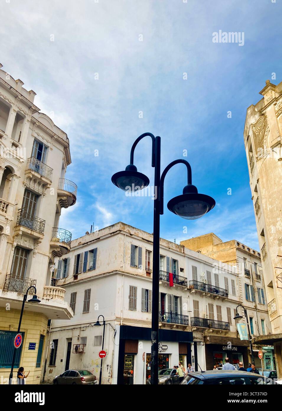 Street view in the old medina of Tunis, Tunisia. Ornate lamp post ...