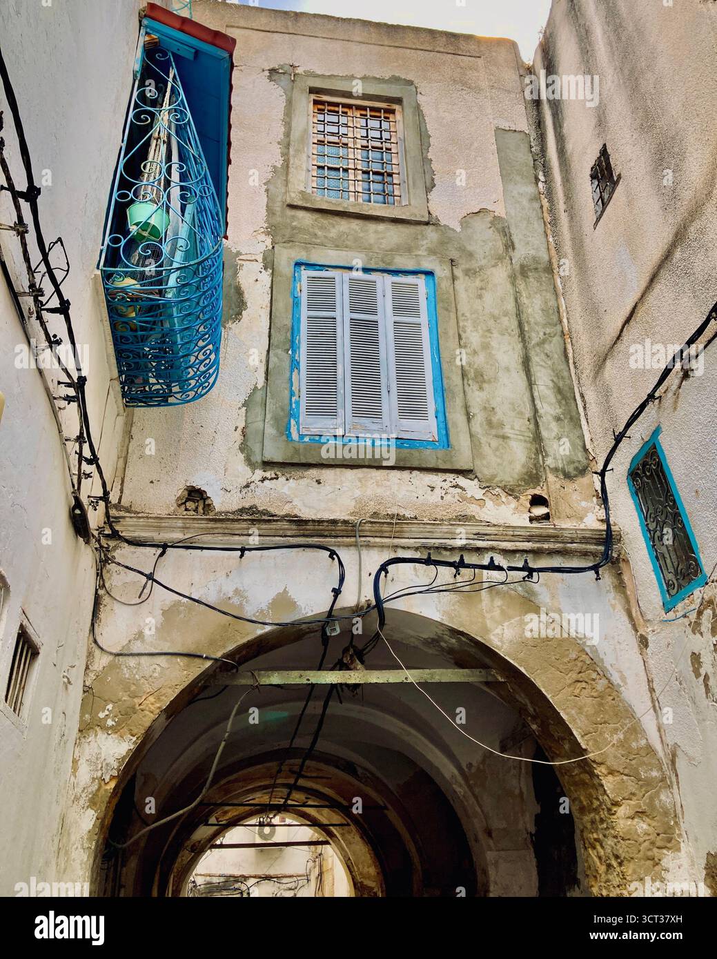 Street view in the old medina of Tunis, Tunisia. Ornate lamp post ...