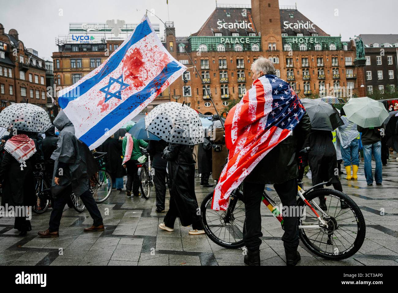 Demonstrators hold red-stained flags from Israel, left, and the United ...