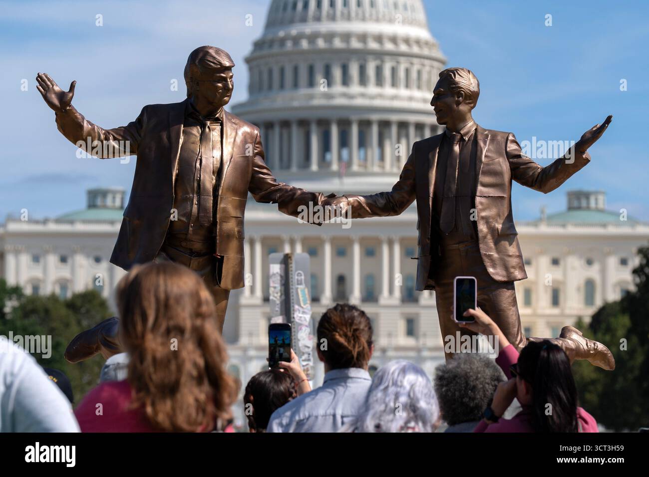 People take pictures to an art installation representing President ...