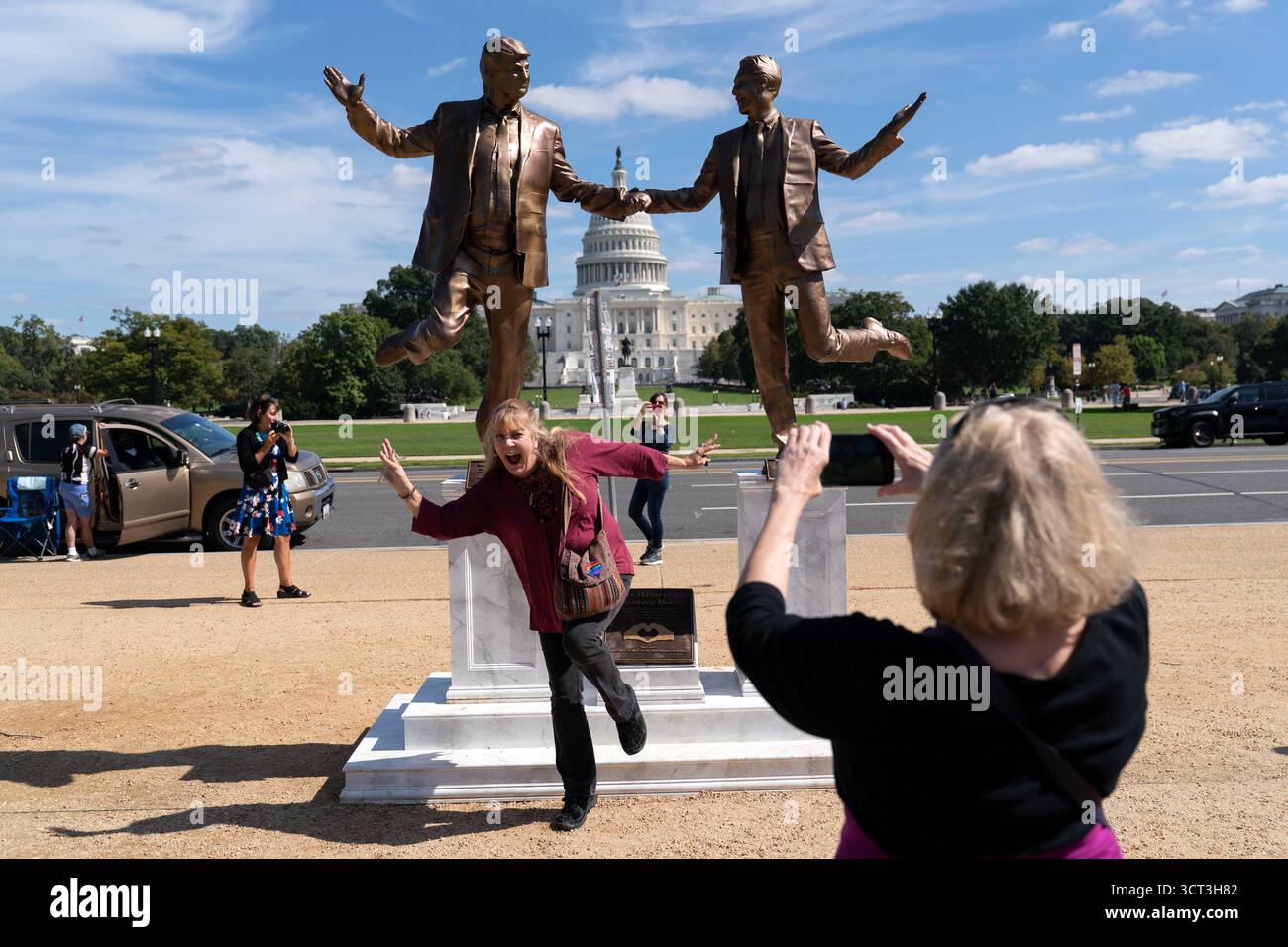 People take pictures to an art installation representing President ...