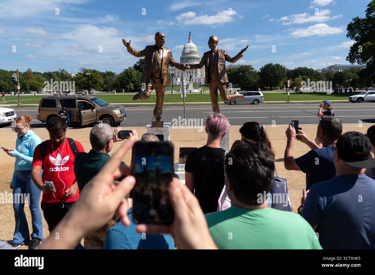 People take pictures to an art installation representing President ...