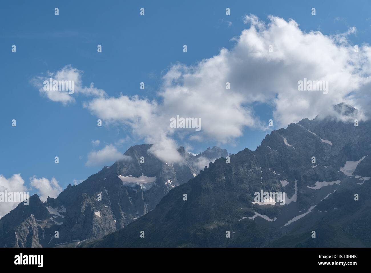 Mountain peaks in the High Alps in the clouds Stock Photo - Alamy