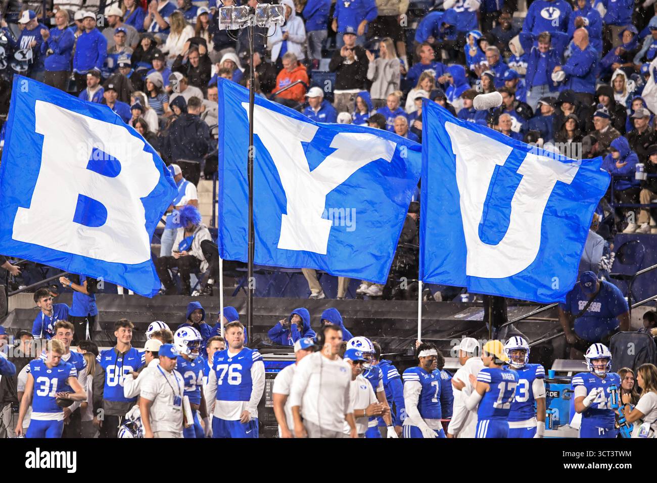 PROVO, UT - OCTOBER 03: BYU Cheerleaders run with "BYU" flags after a ...