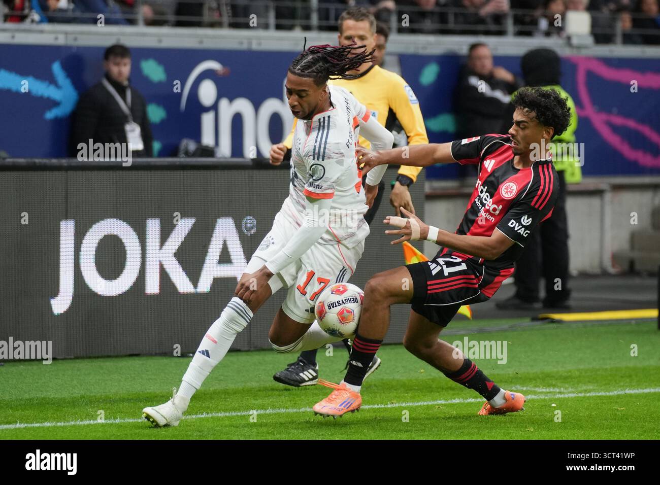 Bayern's Michael Olise, left, and Frankfurt's Nathaniel Brown challenge ...