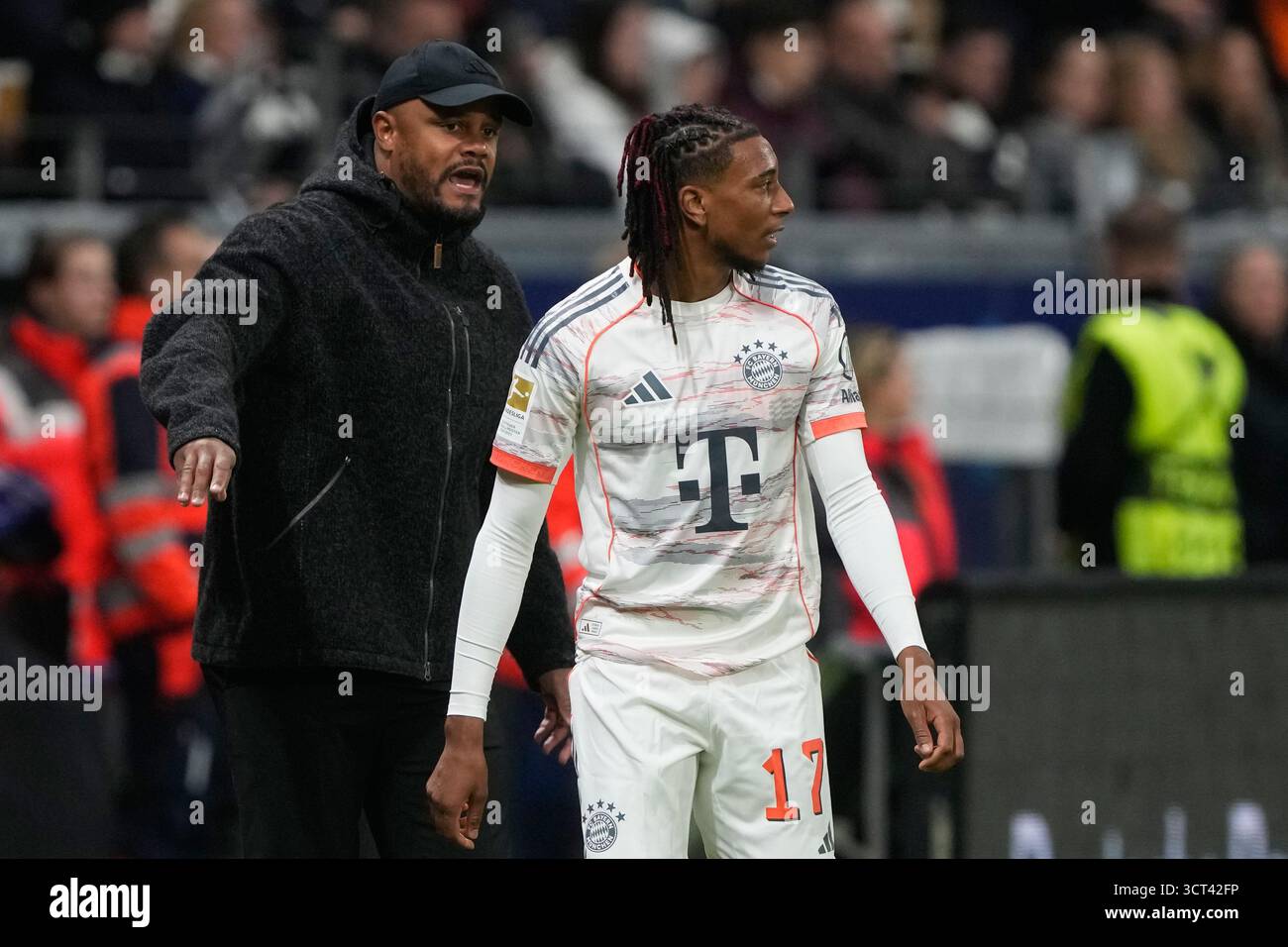 Bayern's head coach Vincent Kompany gestures behind Michael Olise during the Bundesliga soccer ...