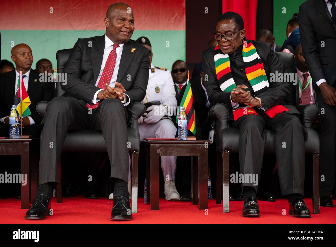 Mozambique's President Daniel Chapo, left, chats with Zimbabwean ...