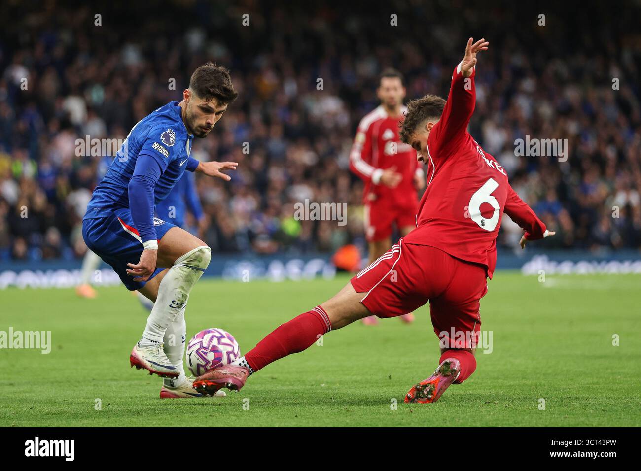 Liverpool's Milos Kerkez, right, challenges Chelsea's Pedro Neto during ...