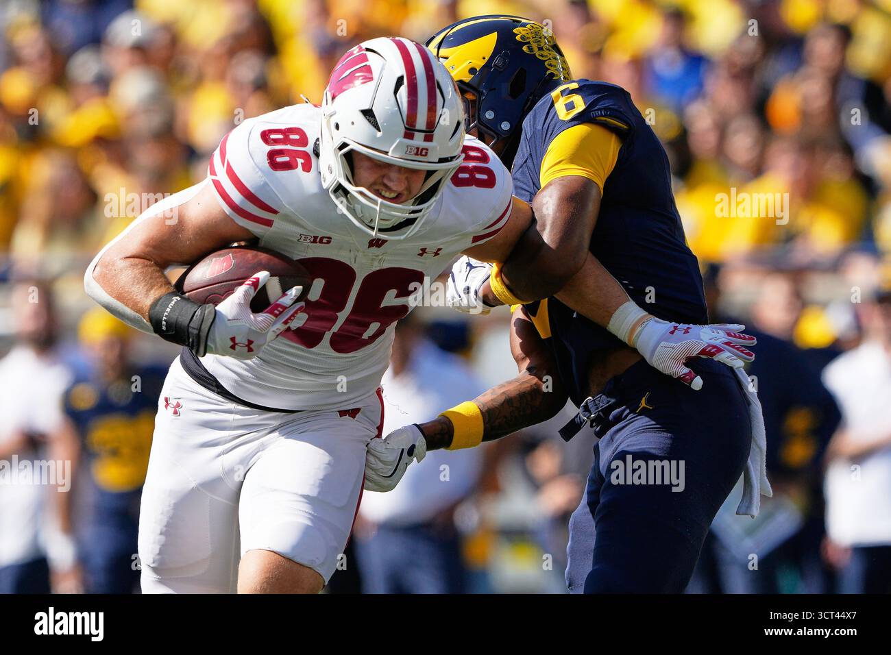 Wisconsin tight end Lance Mason, left, is tackled by Michigan defensive ...