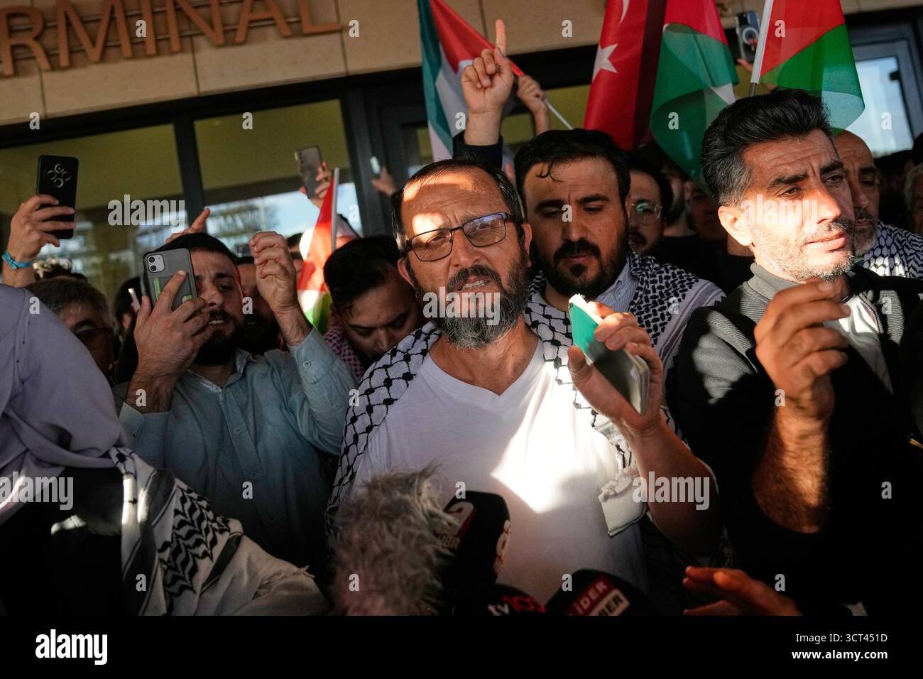 Halil Rifat Canakci, from Turkey, speaks to the media after arriving in ...