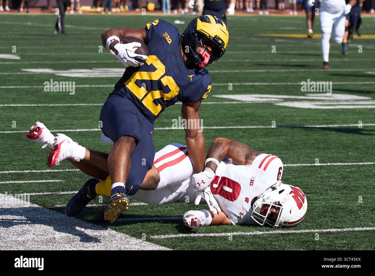 Michigan running back Justice Haynes, left, is tackled by Wisconsin ...