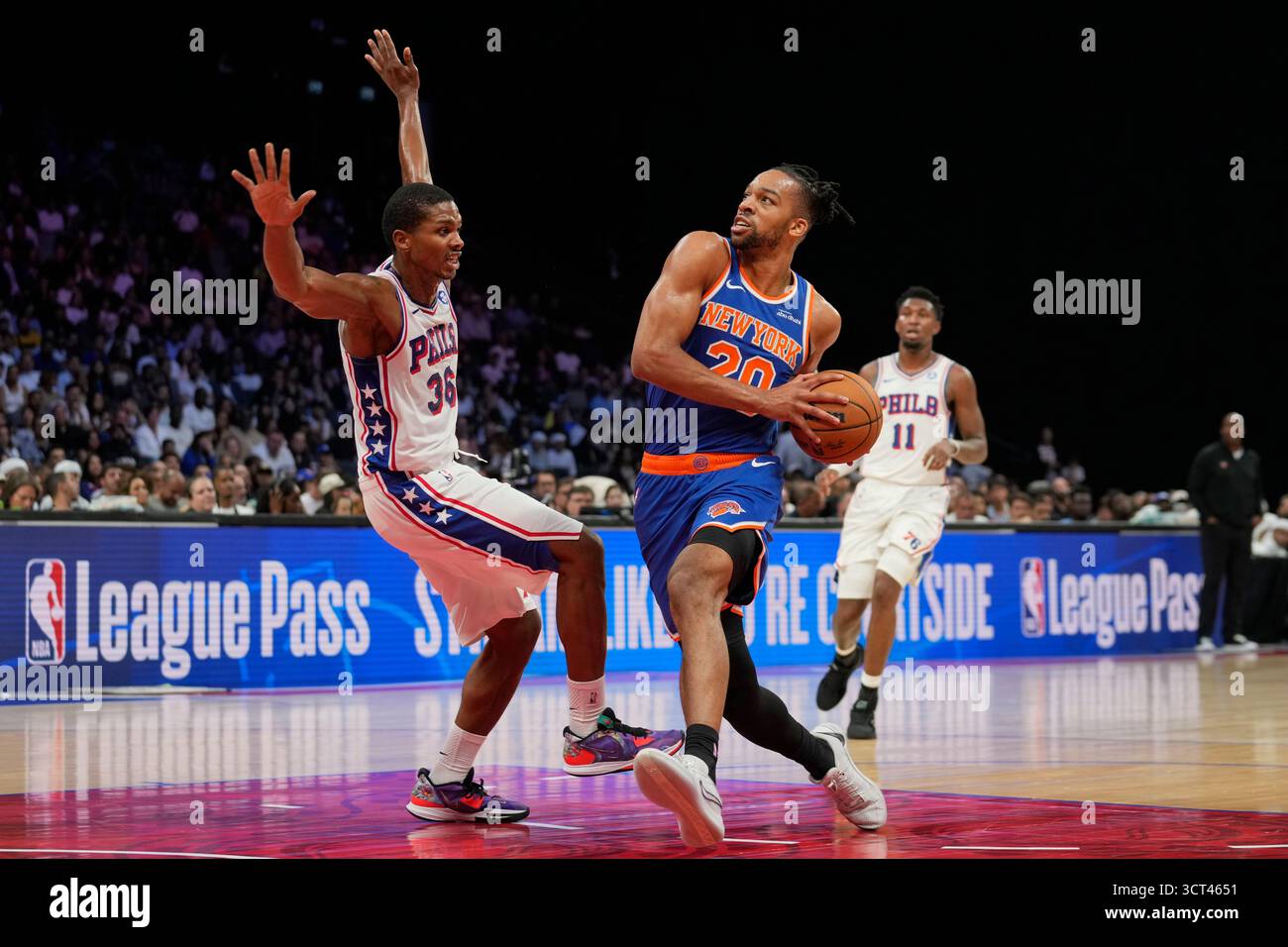 New York Knicks forward Tosan Evbuomwan (20) drives pst Philadelphia 76ers guard Malcolm Hill ...