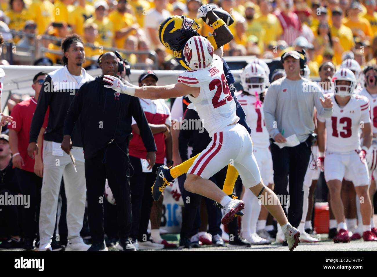 Michigan wide receiver Andrew Marsh, behind, catches a pass over ...