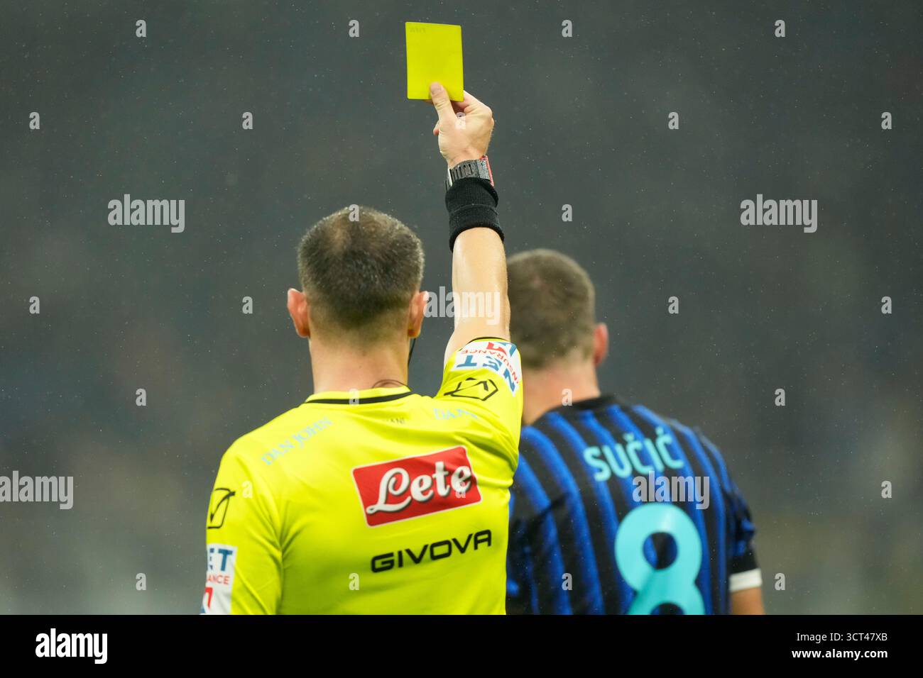 Referee Ermanno Feliciani shows a yellow card to Inter Milan's Petar ...