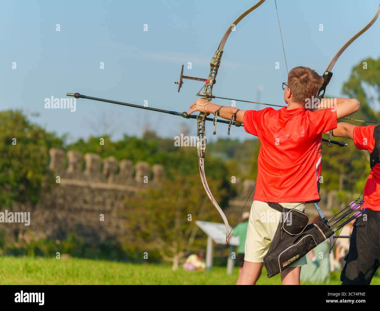 Young Archer Aiming Recurve Bow at Outdoor Event Stock Photo - Alamy