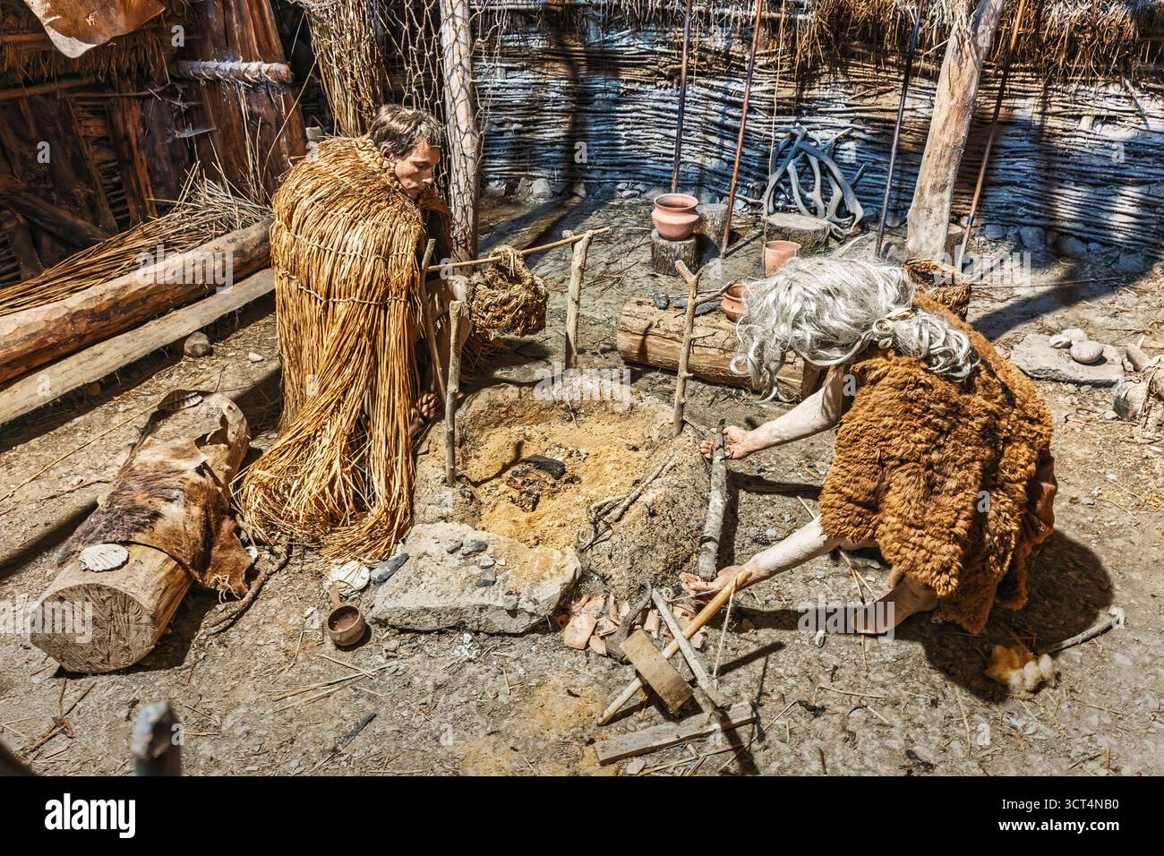 Prehistoric Irish roundhouse interior with wax figures and clay pots ...